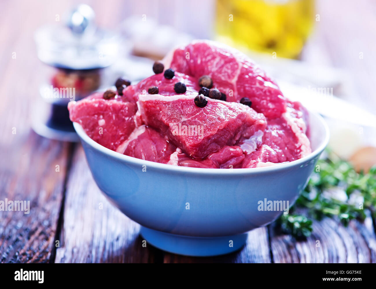 raw meat with aroma sxpice on a kitchen table Stock Photo - Alamy