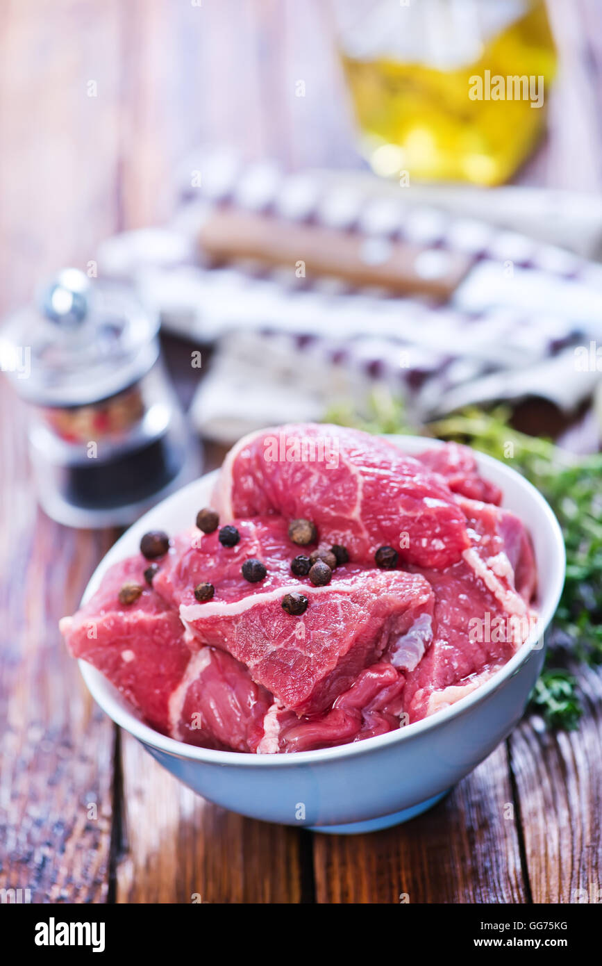 raw meat with aroma sxpice on a kitchen table Stock Photo - Alamy