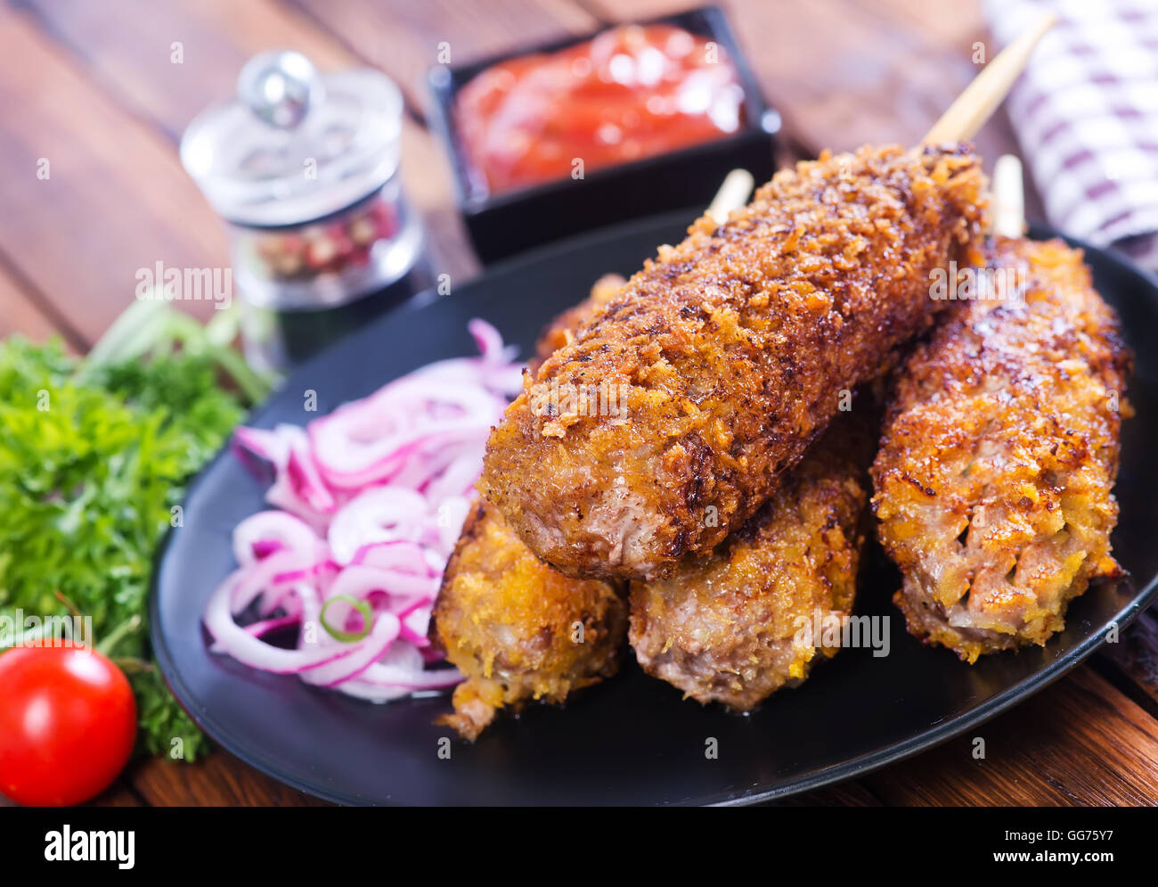 fried kebab with spice and fresh tomato Stock Photo - Alamy