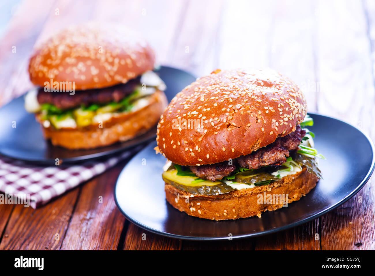 burgers on plate and on a table Stock Photo - Alamy