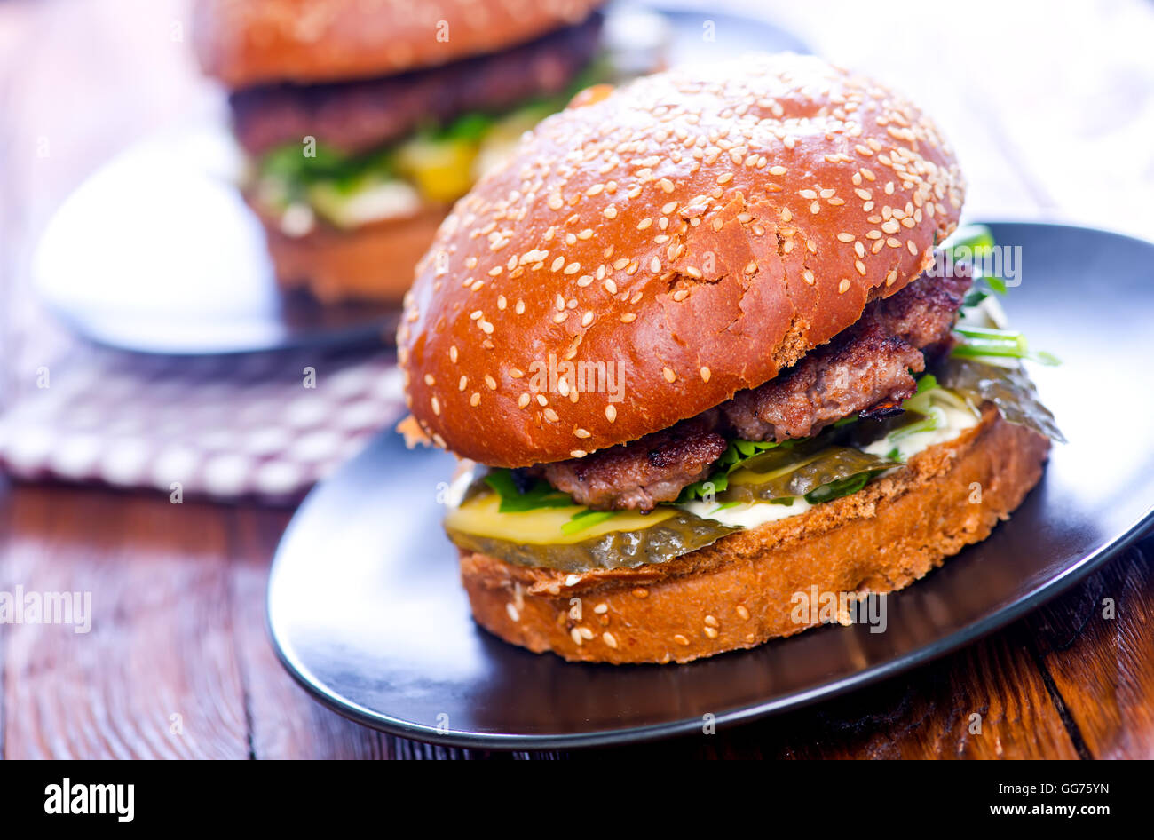 burgers on plate and on a table Stock Photo - Alamy