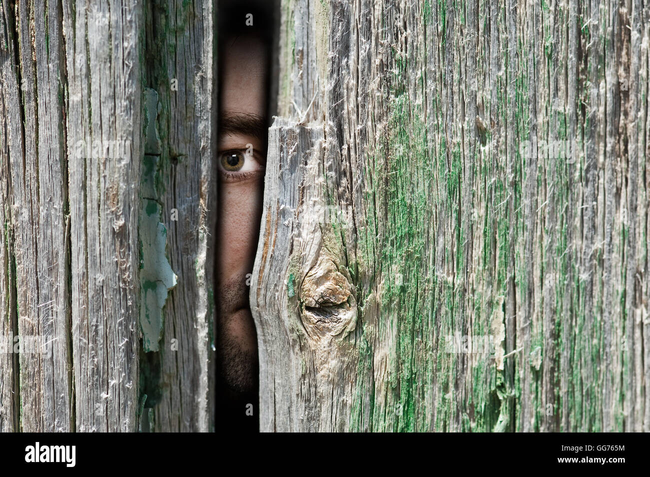 Male person hide behind a wooden wall Stock Photo - Alamy