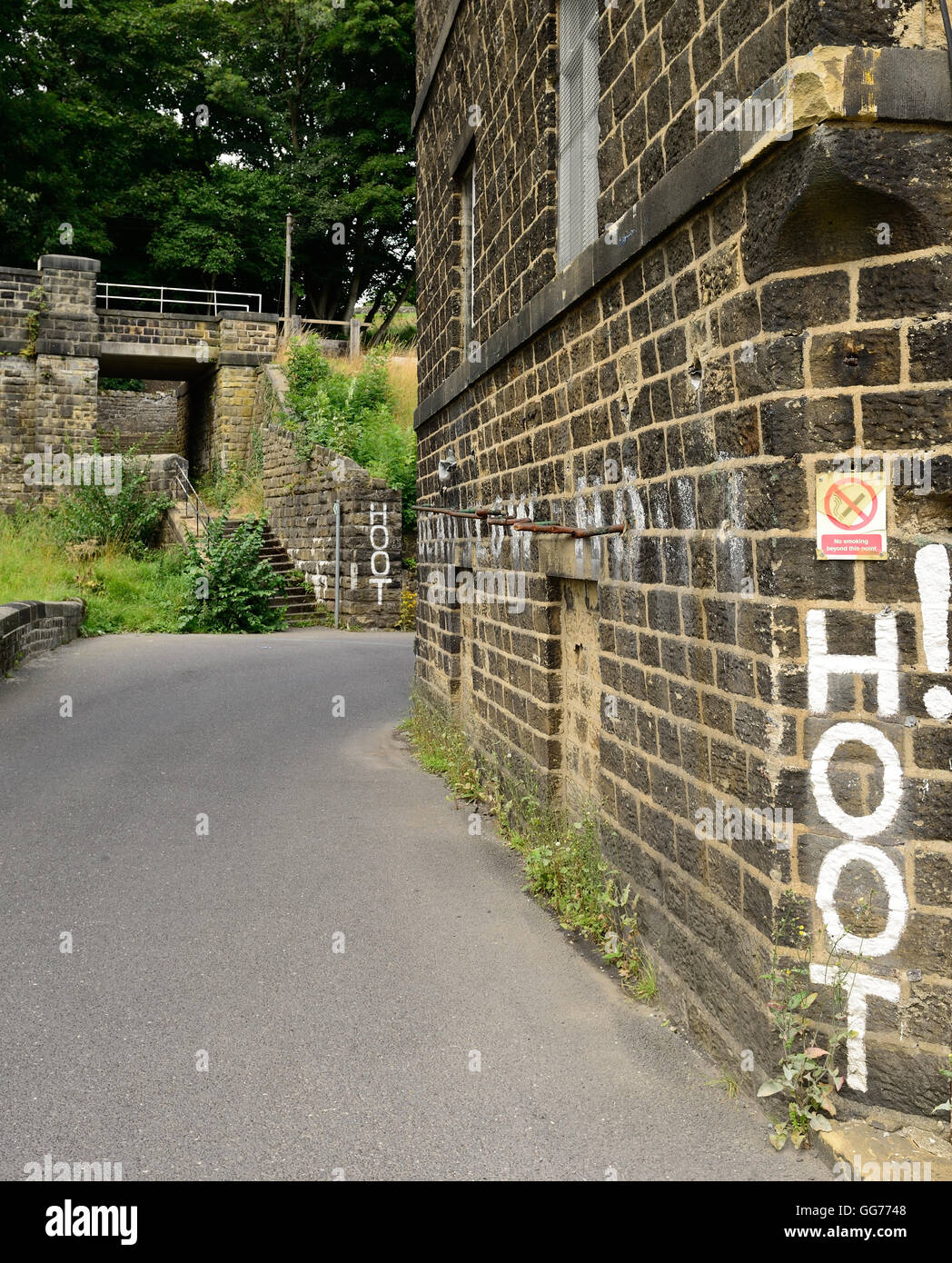 Hoot! Warning signs painted on a building at a blind bend on a narrow ...