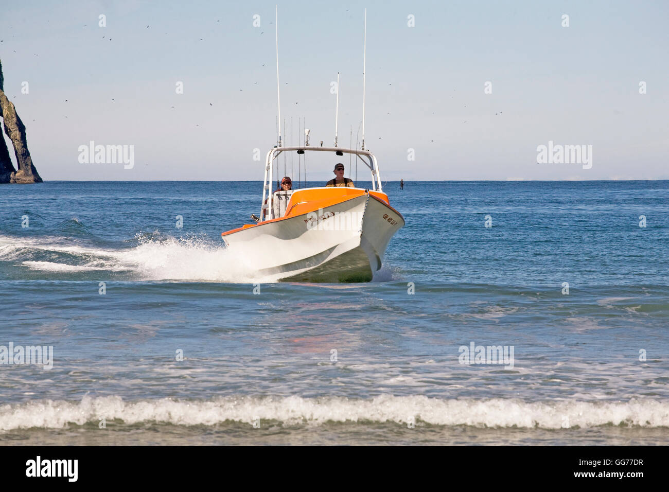 A dory boat lands on the beach at high speed in Pacific City, Oregon ...