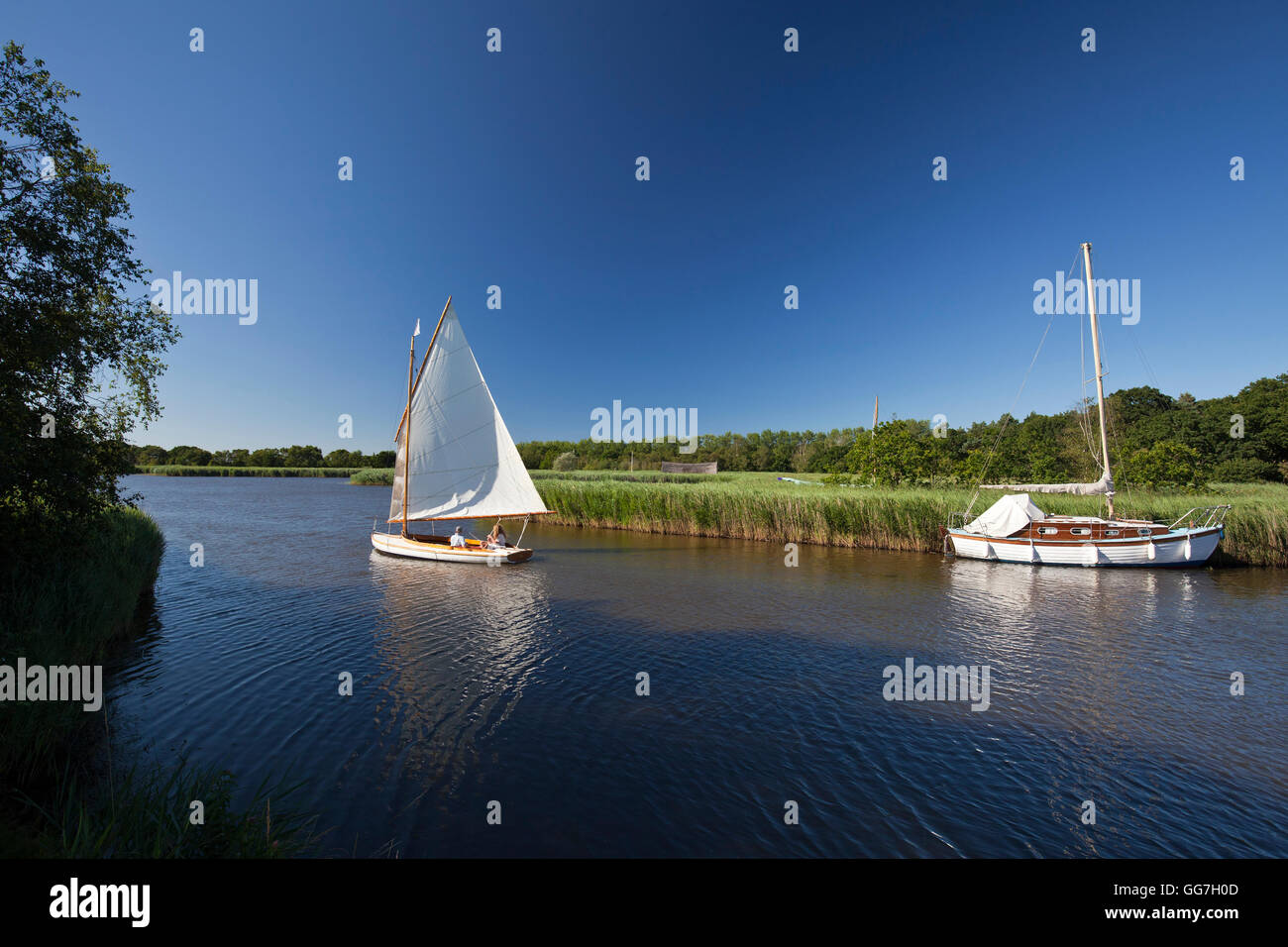Yacht sailing out of Horsey Staithe into Horsey Mere on the Norfolk ...