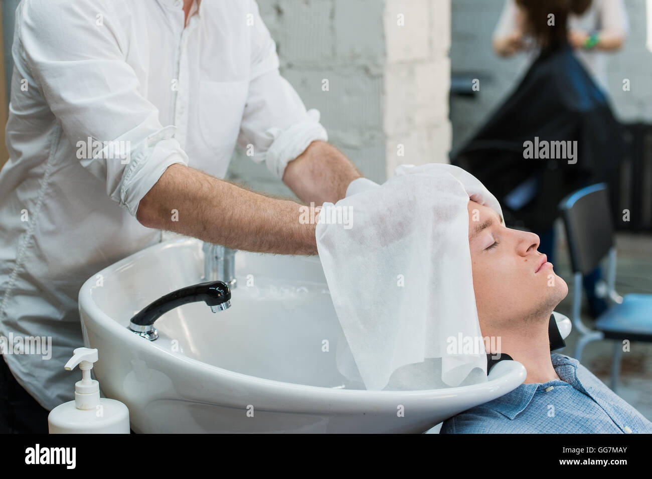 Profile view of a young man getting ready for his hair washed Stock ...