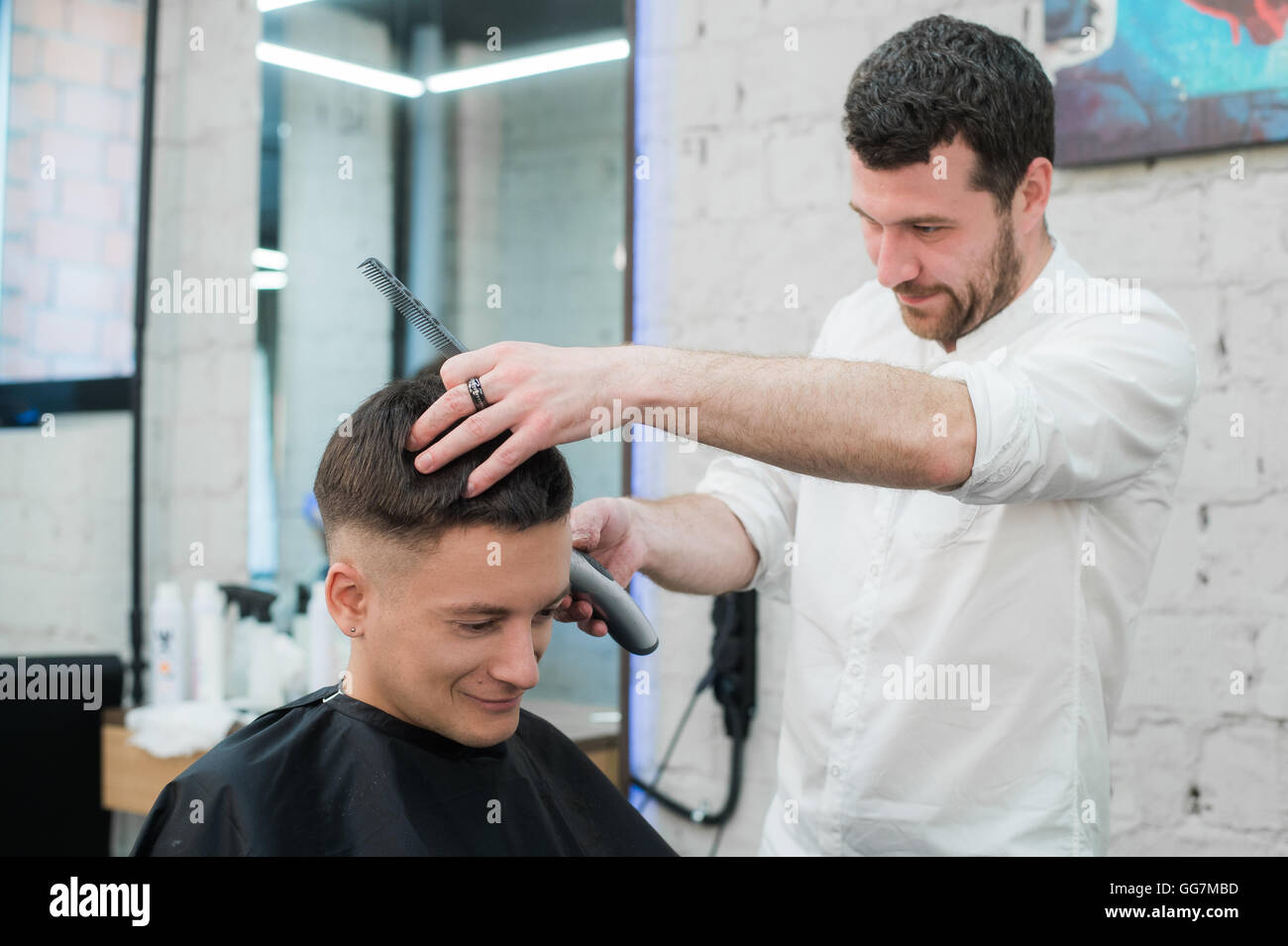 Professional styling. Close up side view of young satisfied man getting ...
