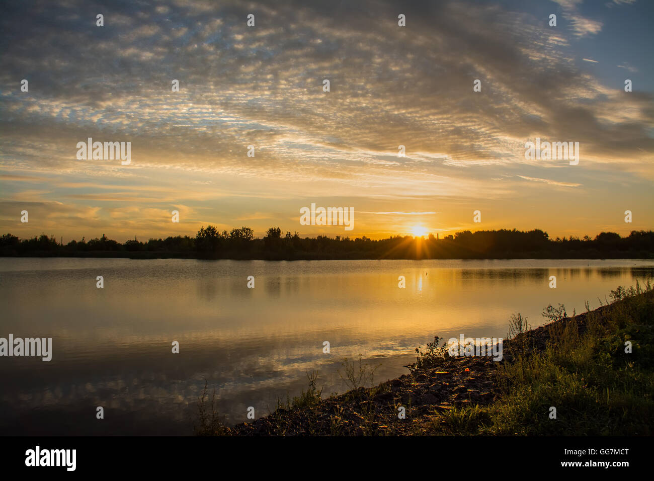 The first rays of the sun in the sky Stock Photo - Alamy