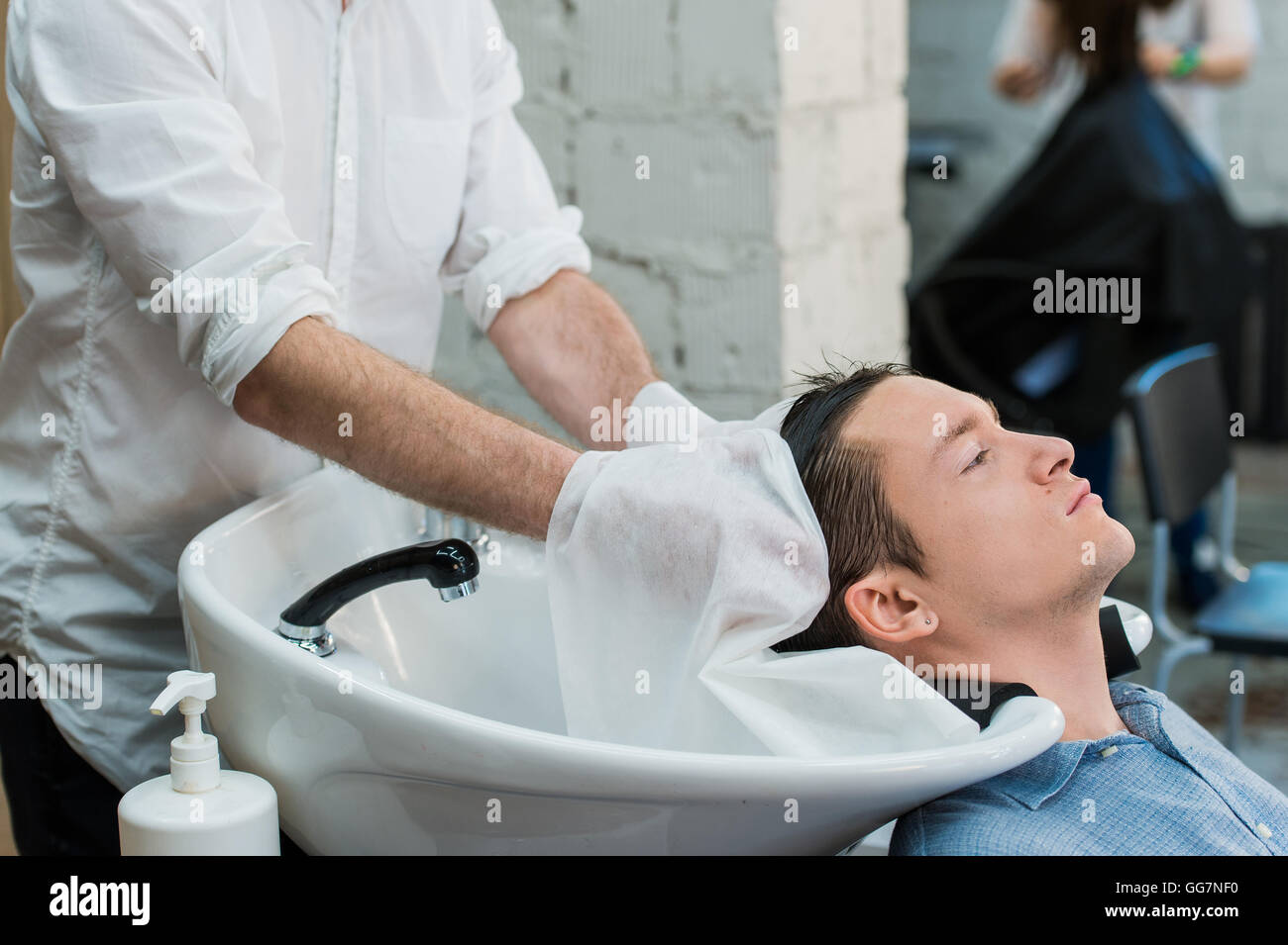 Profile view of a young man getting ready for his hair washed Stock ...