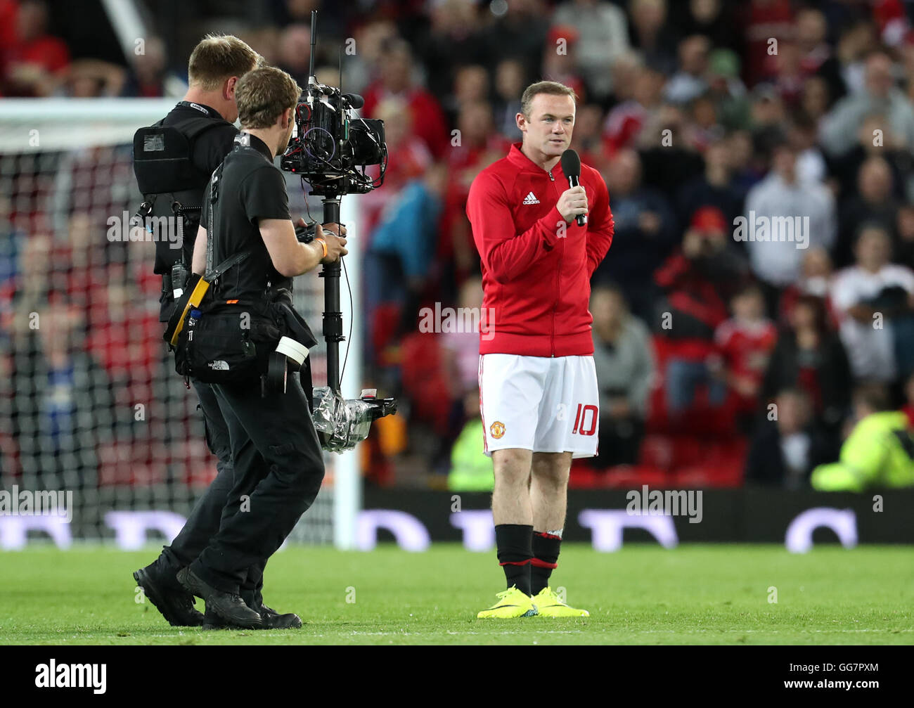 Manchester United's Wayne Rooney gives a speech on the pitch after his ...