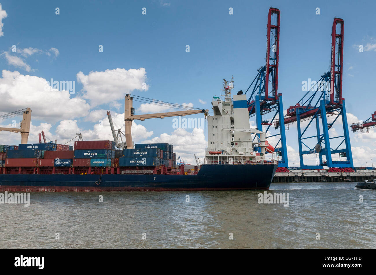 Hamburg, Germany. A container ship in the port of Hamburg is loaded ...