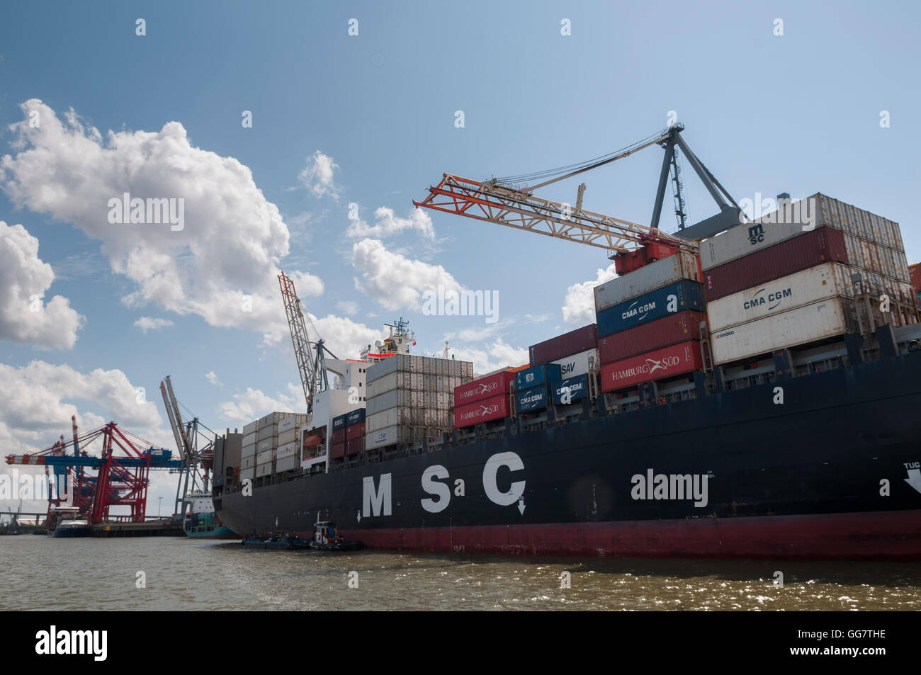 Hamburg, Germany. A container ship in the port of Hamburg is loaded ...