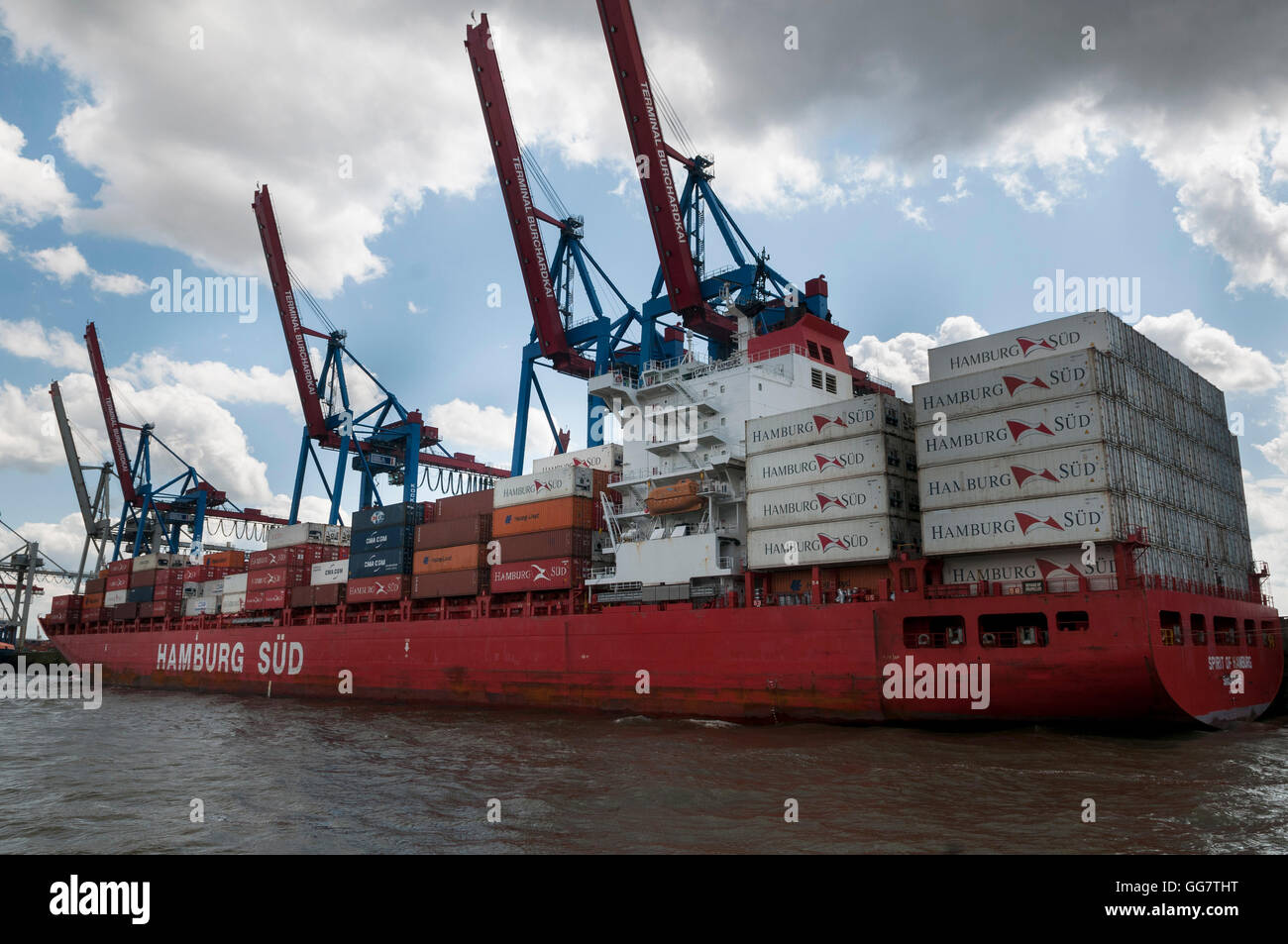 Hamburg, Germany. A container ship in the port of Hamburg is loaded ...