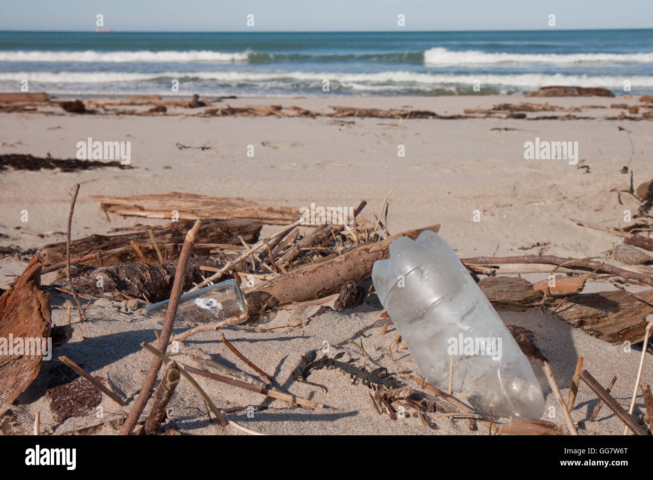 bottles and other plastic littered on a beach in Gisborne, New Zealand ...