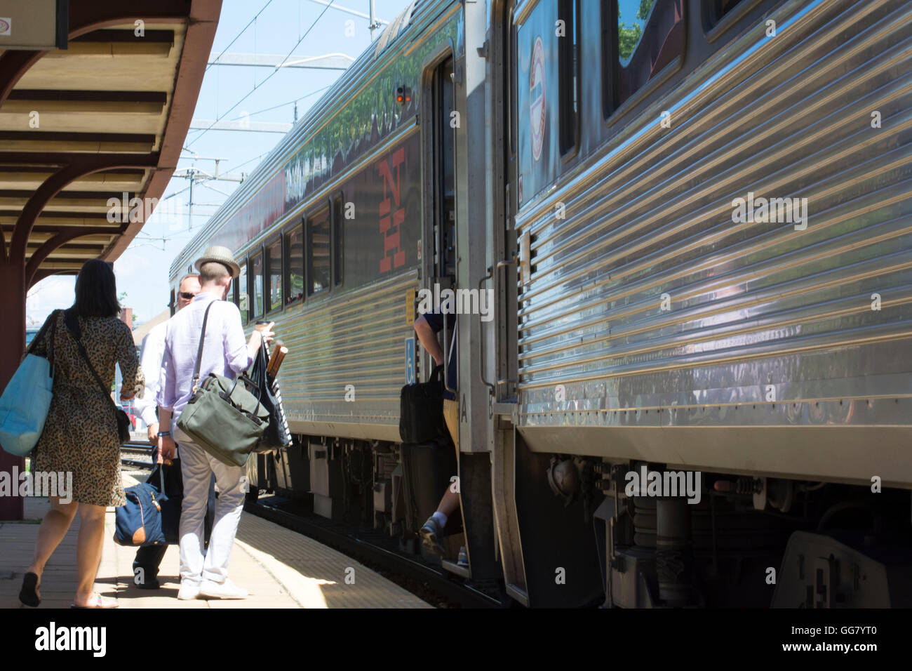 Train station people getting on train Stock Photo - Alamy