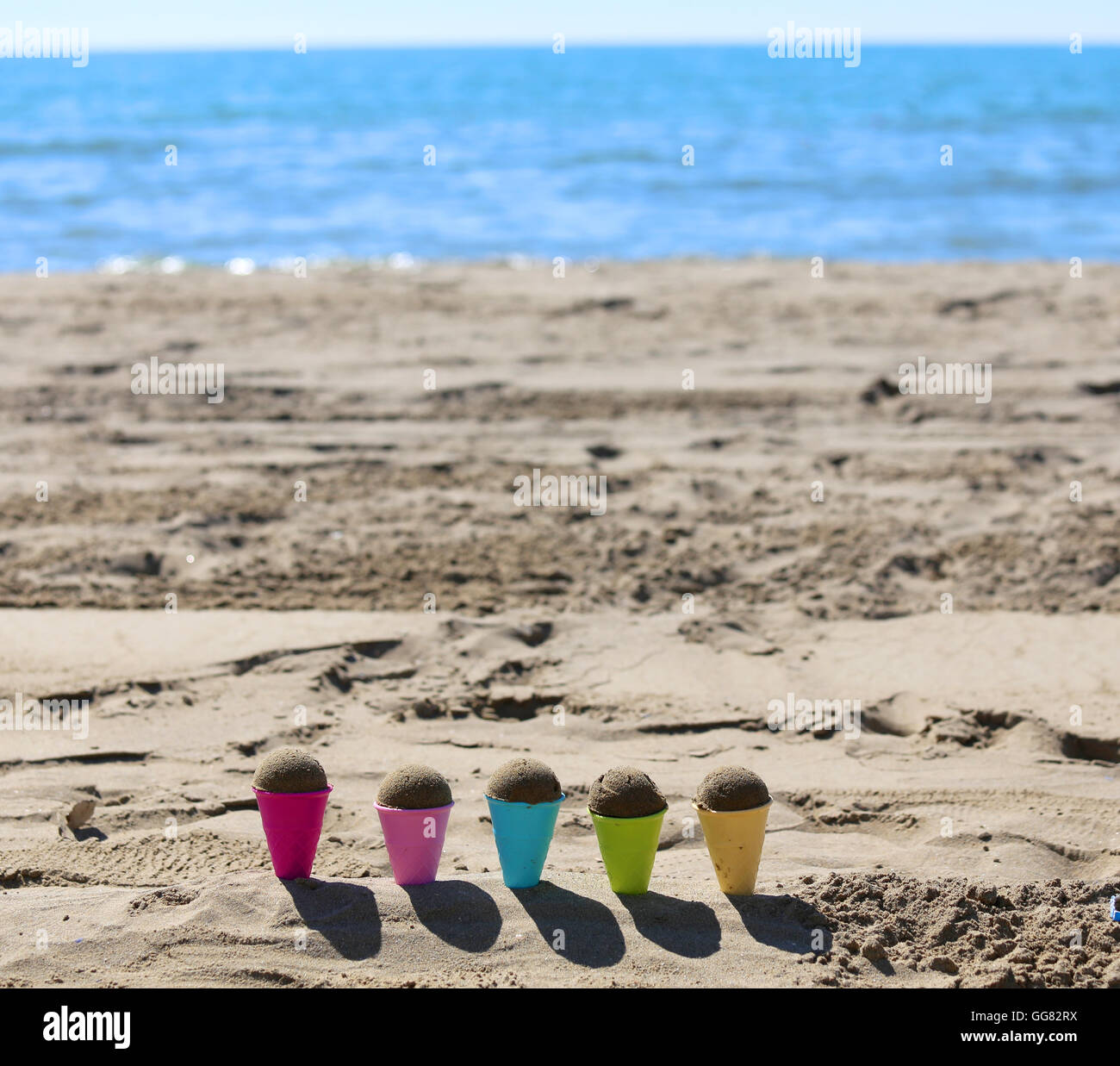five toy ice cream cones on the beach with sand in summer Stock Photo ...