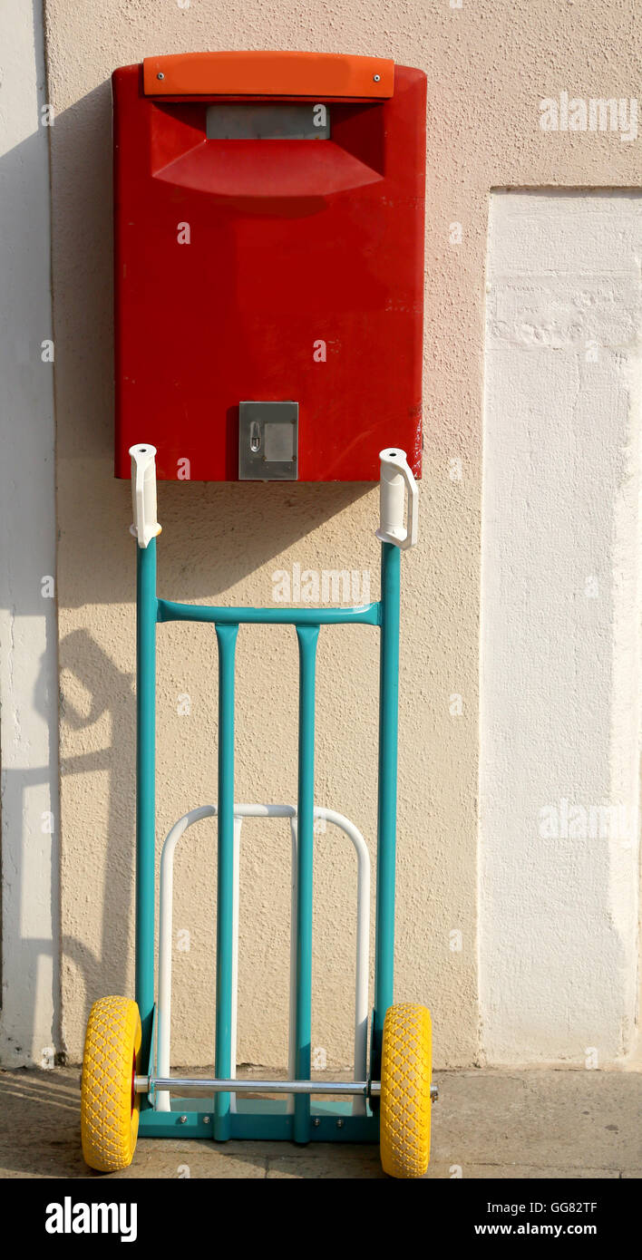 Big Red mailbox with cart for transporting Stock Photo - Alamy