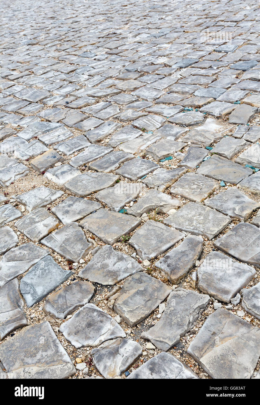 Cobbled road closeup in town as background Stock Photo - Alamy