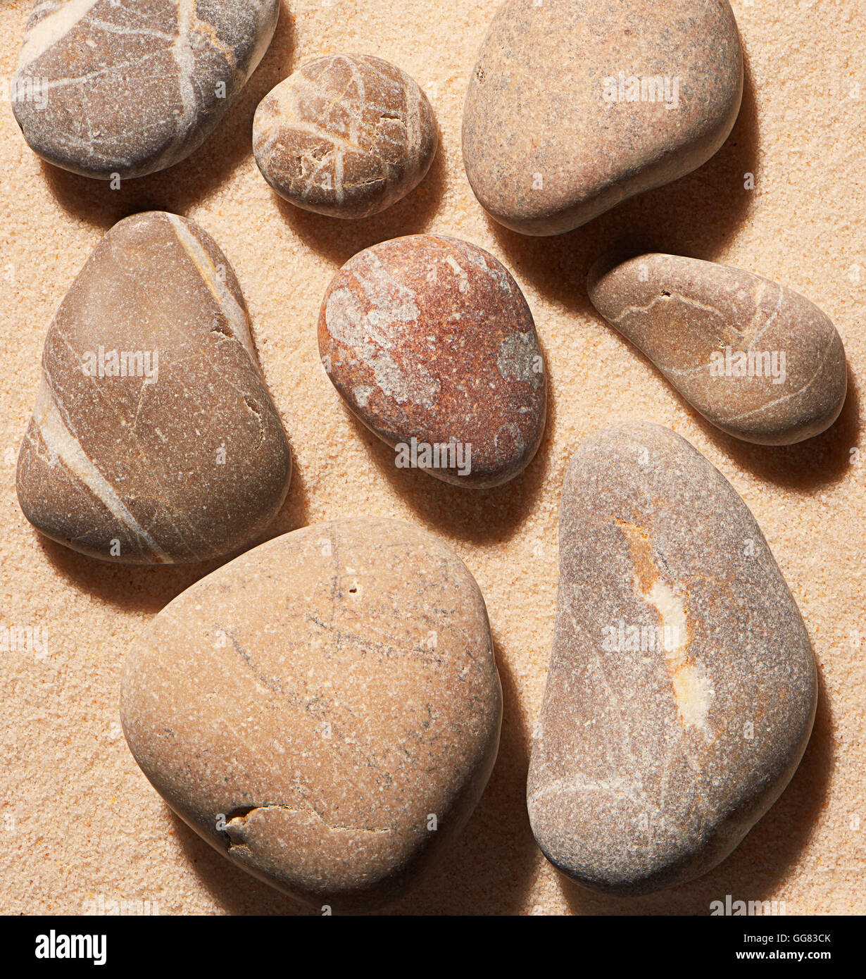 Close up of sea stones on sand. Summer beach background. View from ...