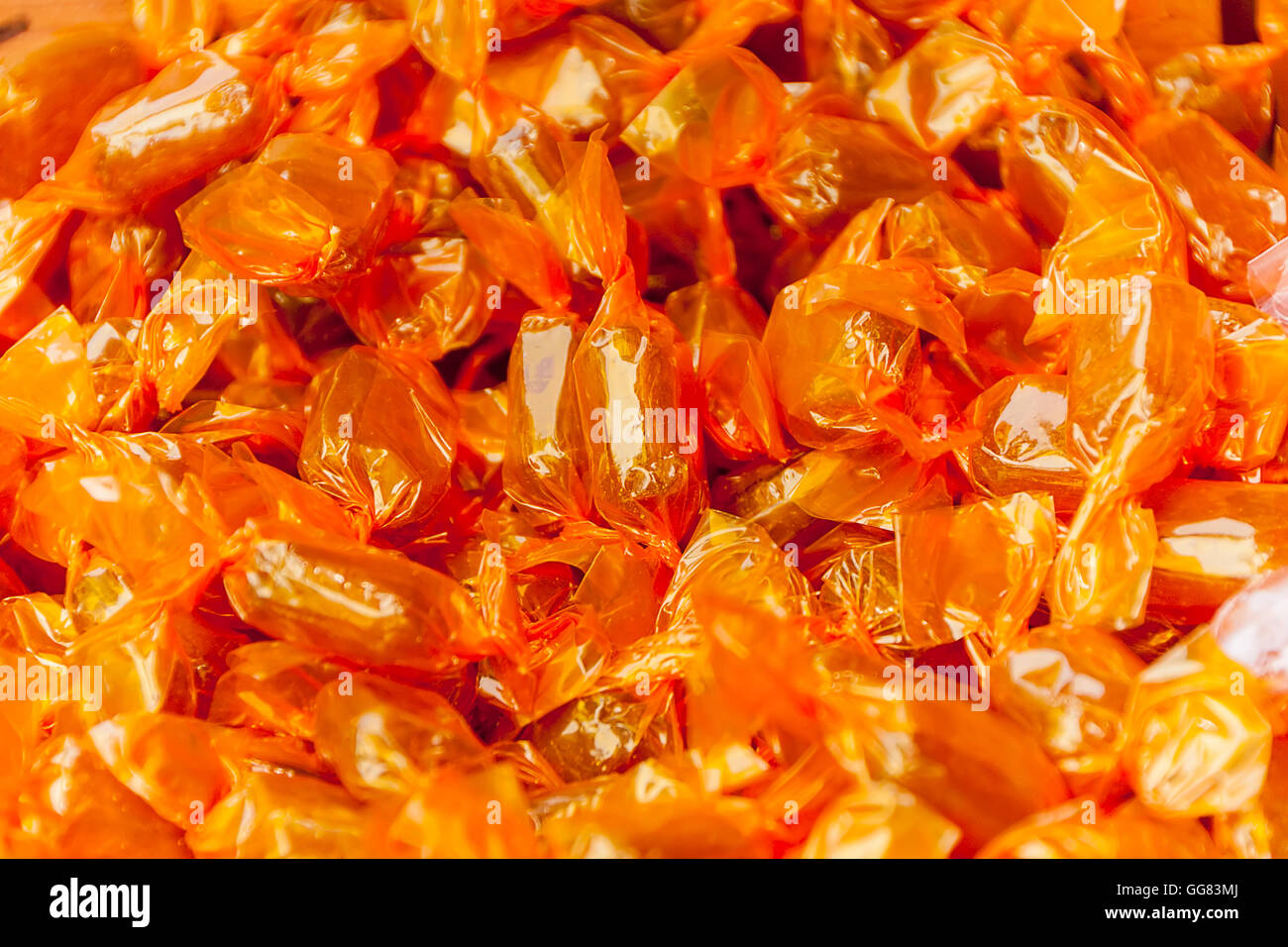 Orange caramels closeup on a craftsmen's market. Horizontal image Stock ...