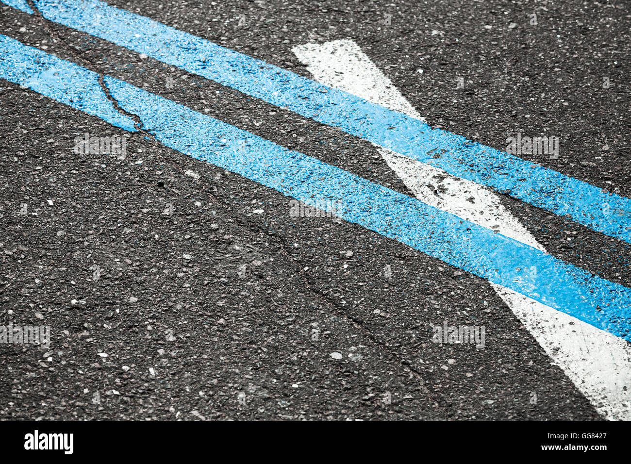 Blue double dividing line over one white on highway asphalt, closeup ...