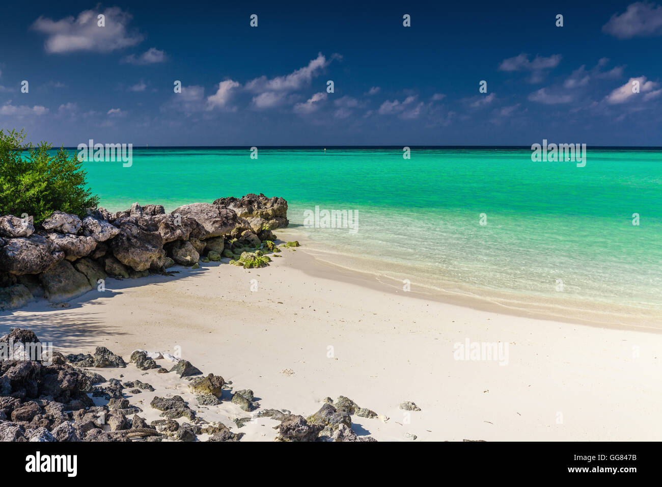 Small secluded beach protected by rocks on a tropical island woth soft ...
