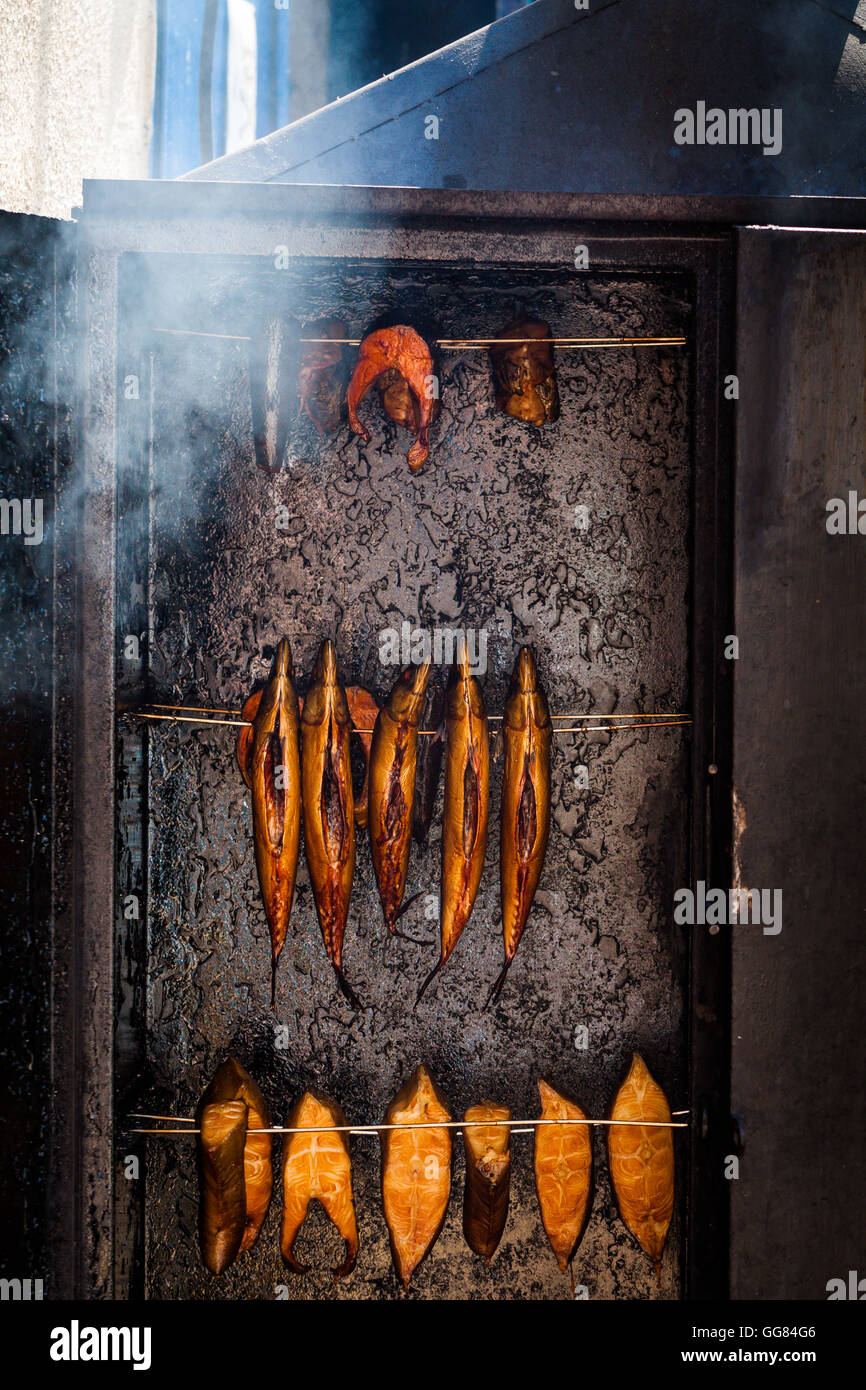 Fresh smoked fish in steel smokehouse with opened door Stock Photo - Alamy