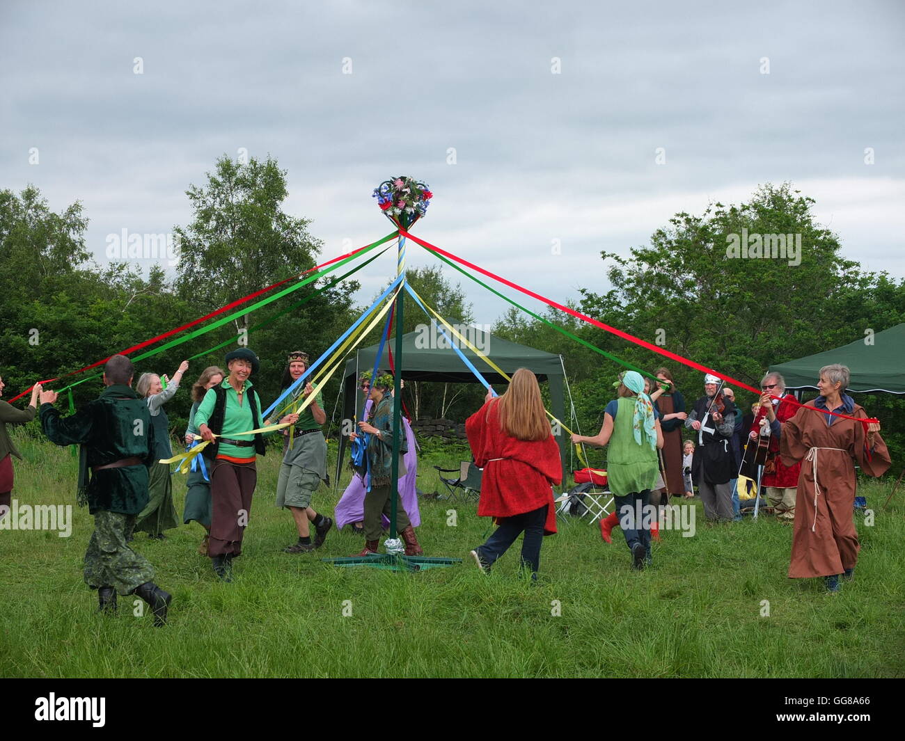 Costumed participants dance round a maypole at Robin Hood Day on ...