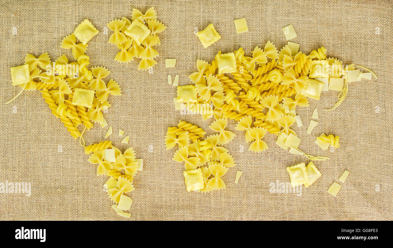 map of the world made of raw pasta on brown fabric background with ...