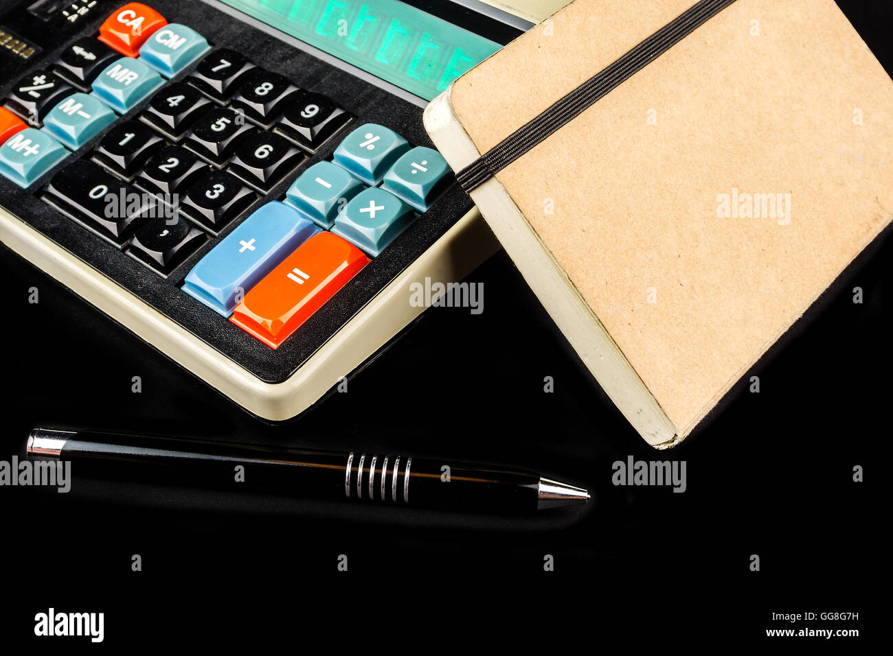 retro style calculator with a pen and diary on black background Stock ...
