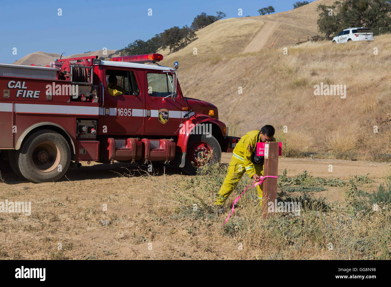 Diablo Grande, CA, USA. 3rd Aug, 2016. A CalFire firefighter marks a ...