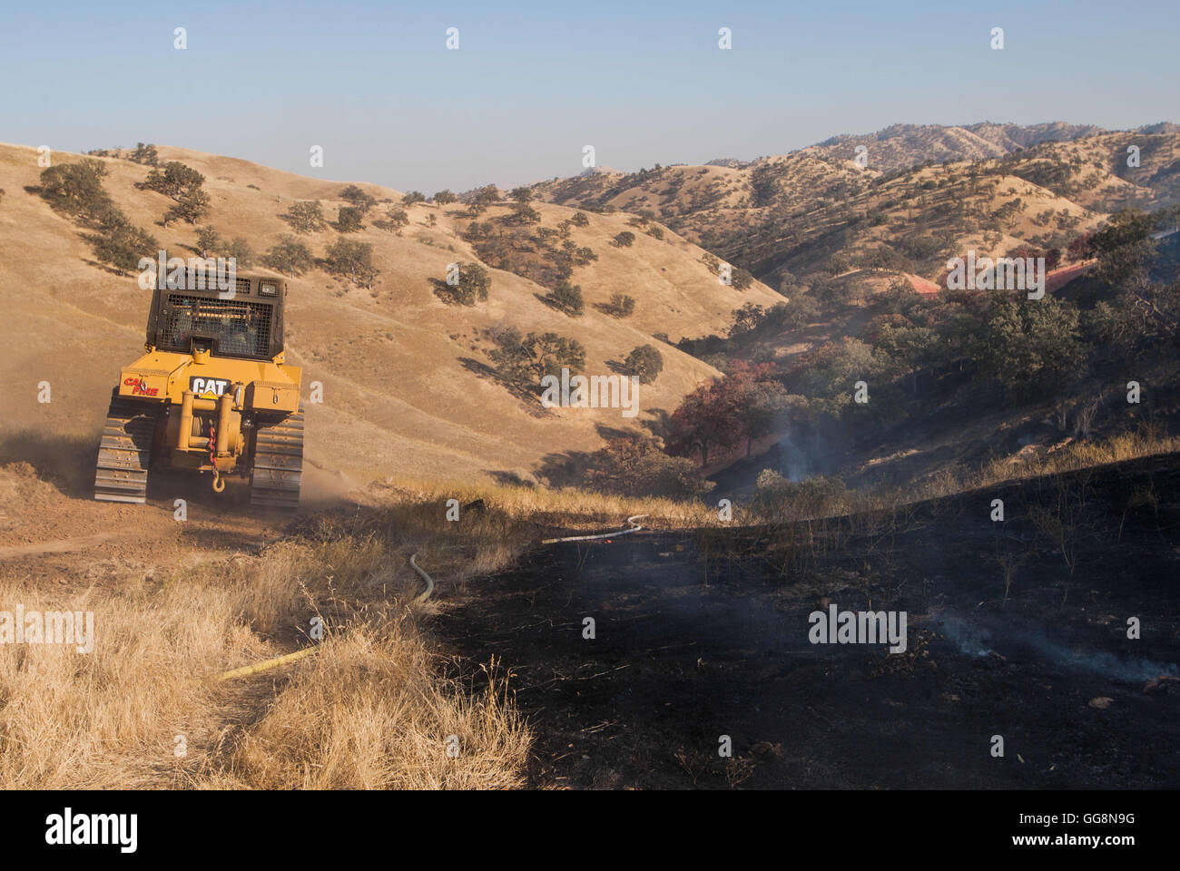 Diablo Grande, CA, USA. 3rd Aug, 2016. A CalFire dozer cuts a fire ...