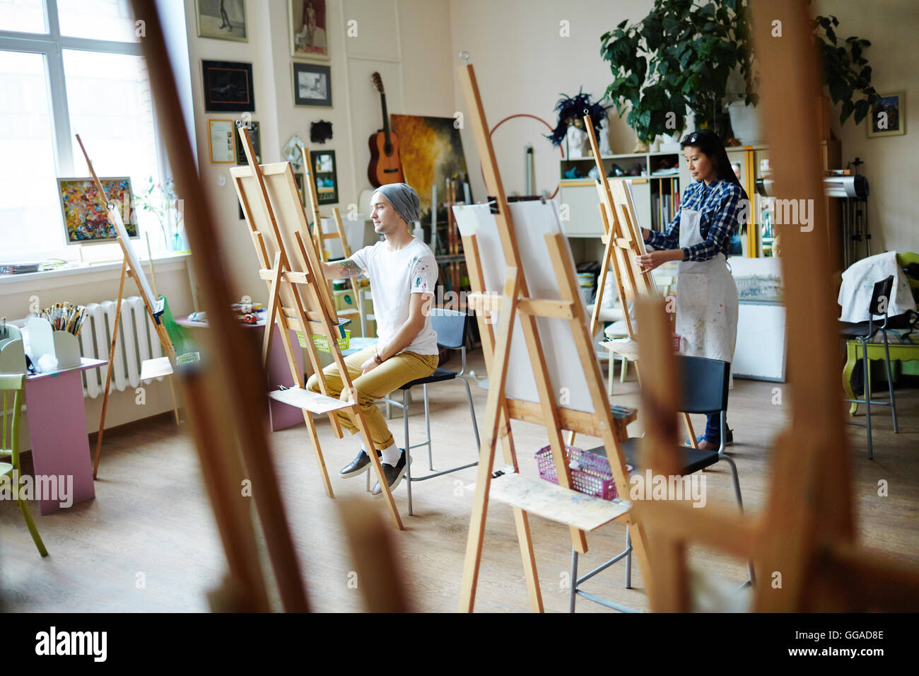 Working on a painting Stock Photo - Alamy