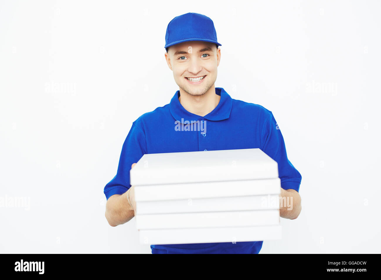 Smiling pizza delivery man holding hi-res stock photography and images ...