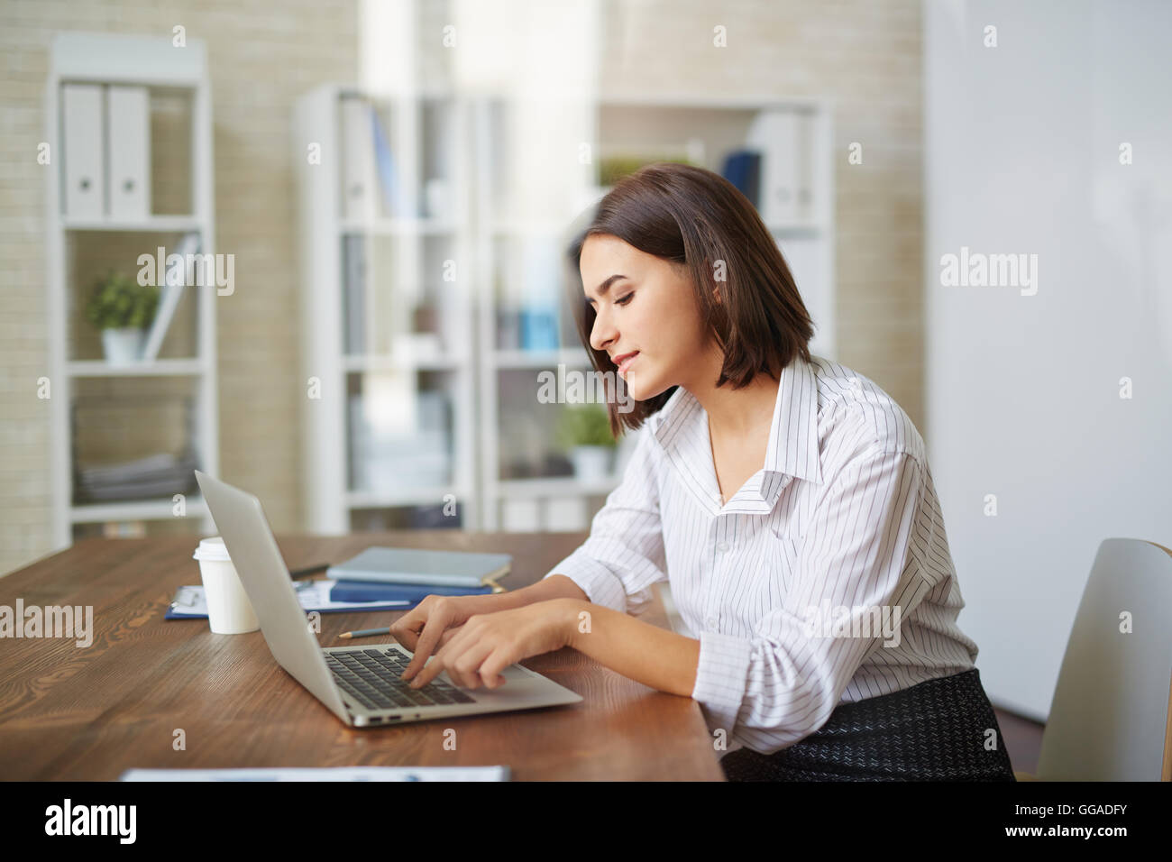 Working on laptop Stock Photo - Alamy