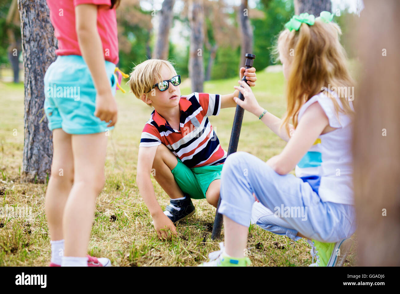 Child sitting playing outdoors hi-res stock photography and images - Alamy