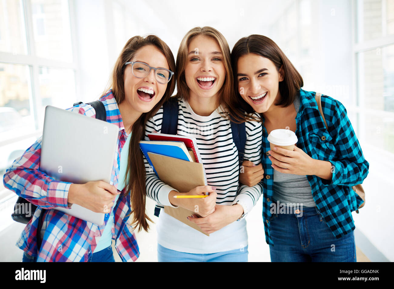 Happy classmates standing studying together hi-res stock photography ...