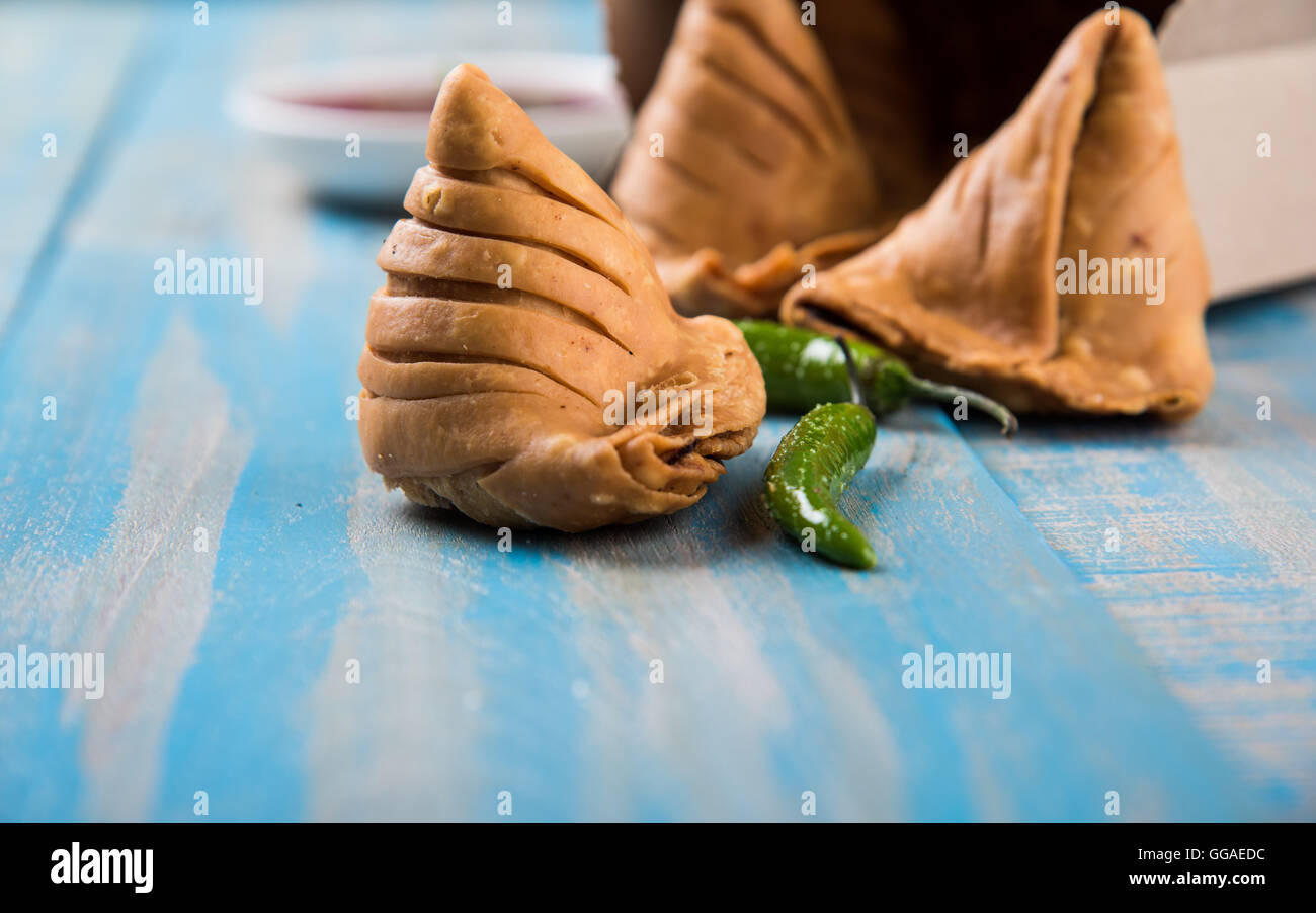 Samosa snack with tomato ketchup and hot tea, Fresh samosas with ...