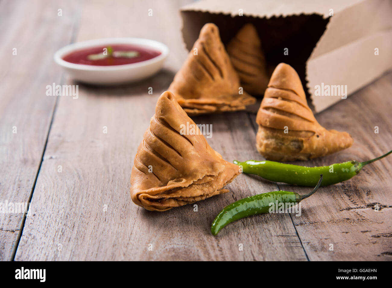 Samosa snack with tomato ketchup and hot tea, Fresh samosas with ...