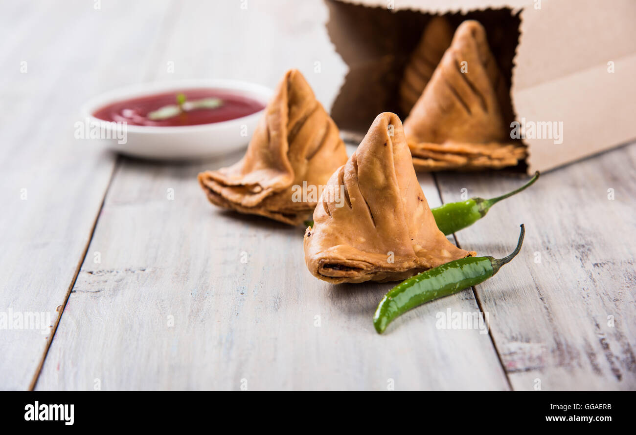 Samosa snack with tomato ketchup and hot tea, Fresh samosas with ...