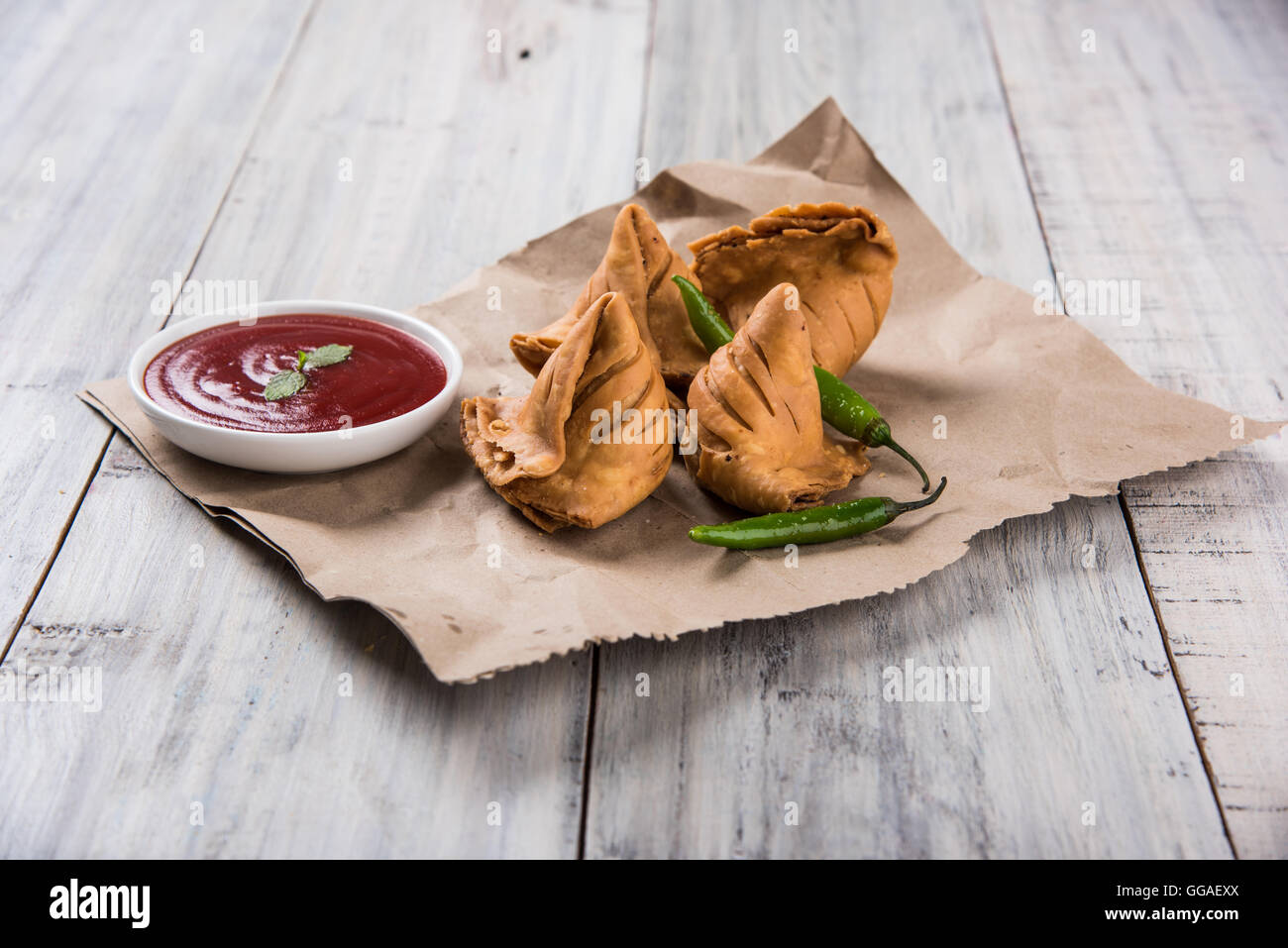 Samosa snack with tomato ketchup and hot tea, Fresh samosas with ...