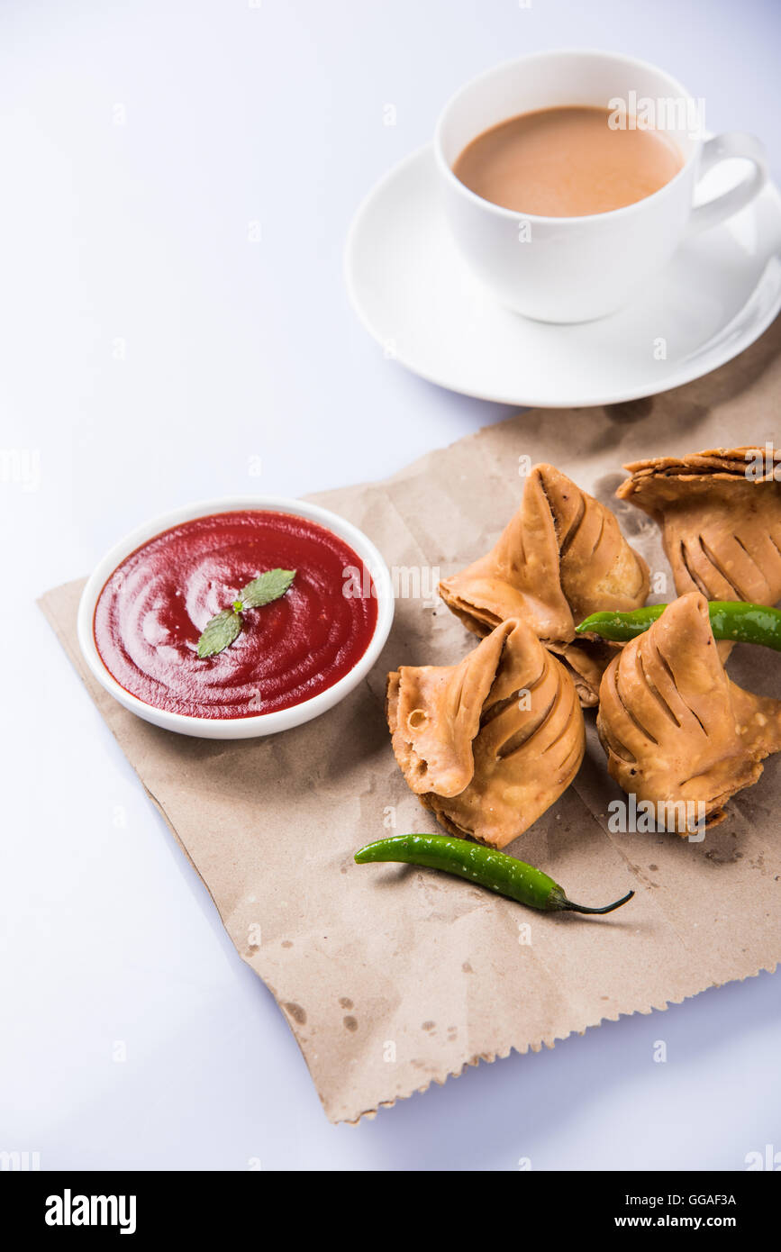 Samosa snack with tomato ketchup and hot tea, Fresh samosas with ...