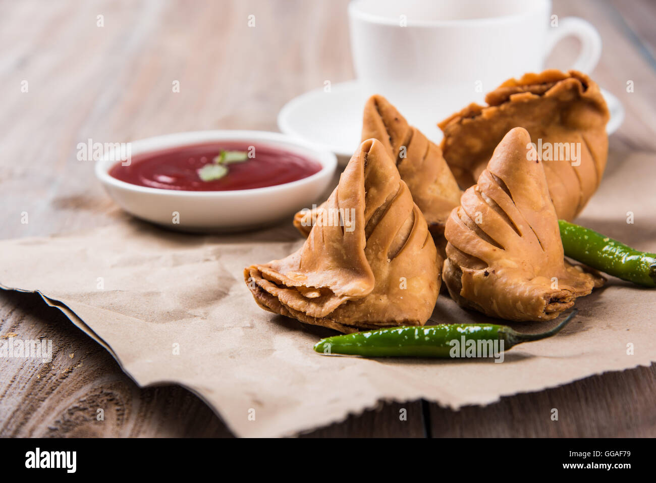 Samosa snack with tomato ketchup and hot tea, Fresh samosas with ...