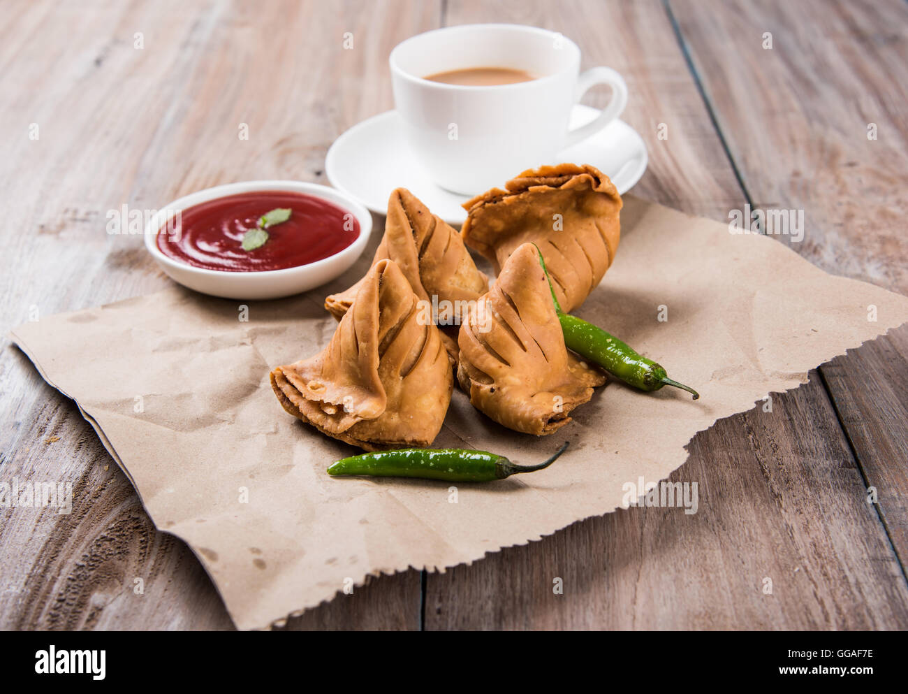 Samosa snack with tomato ketchup and hot tea, Fresh samosas with ...