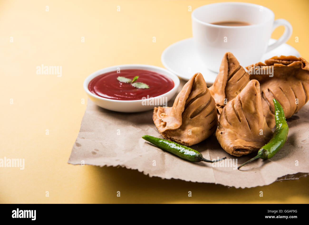 Samosa snack with tomato ketchup and hot tea, Fresh samosas with ...