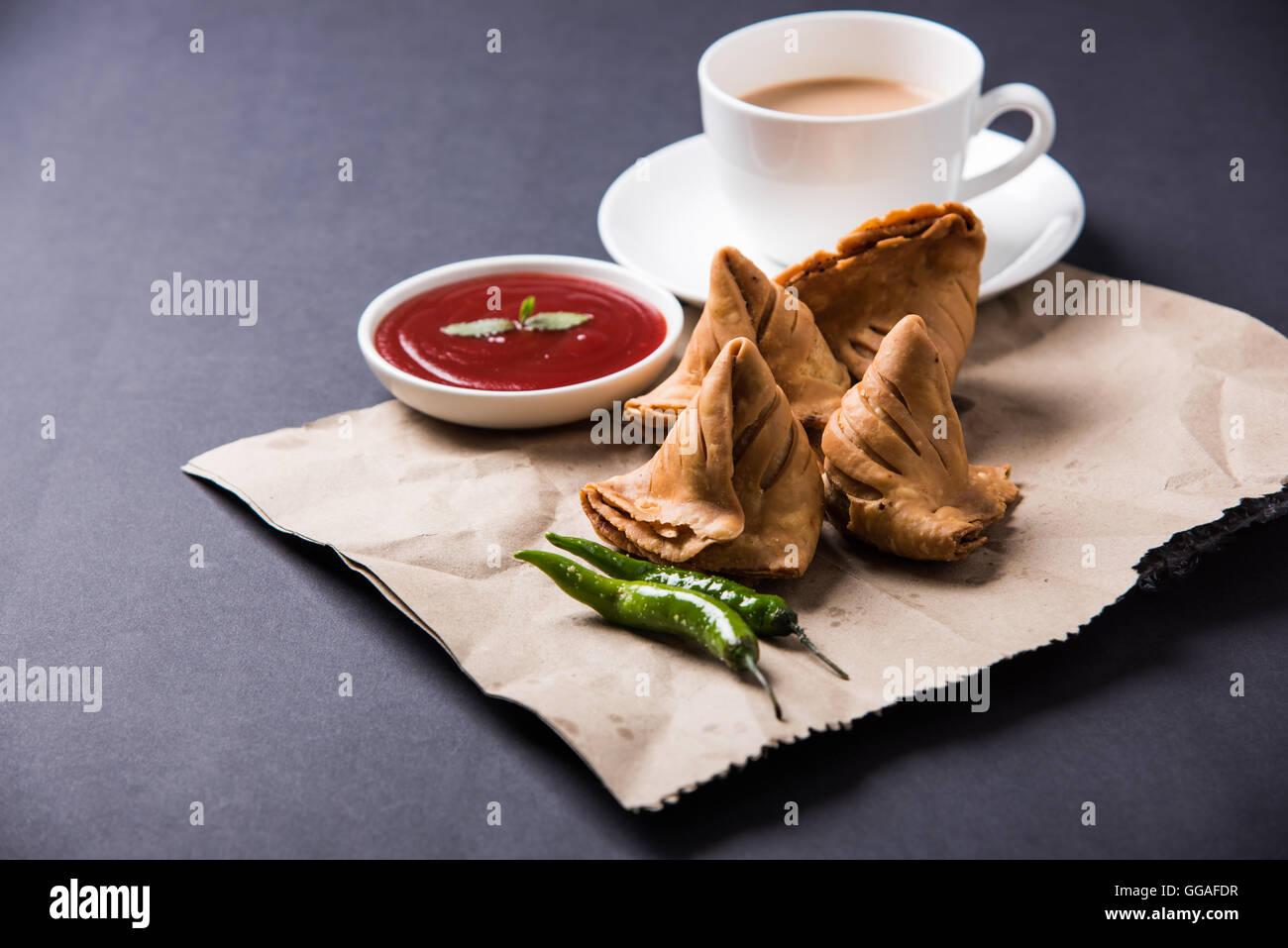 Samosa snack with tomato ketchup and hot tea, Fresh samosas with ...