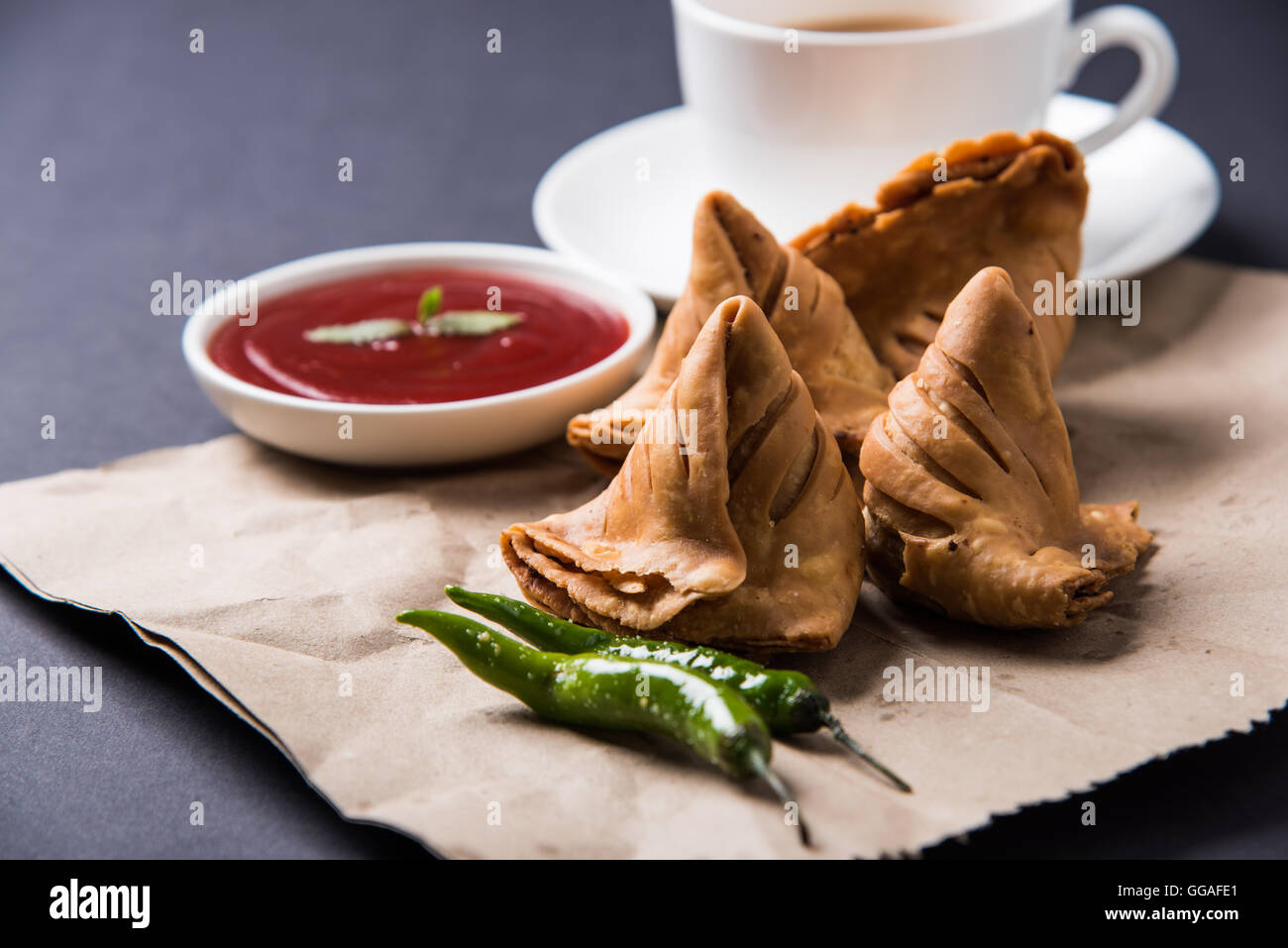 Samosa snack with tomato ketchup and hot tea, Fresh samosas with ...