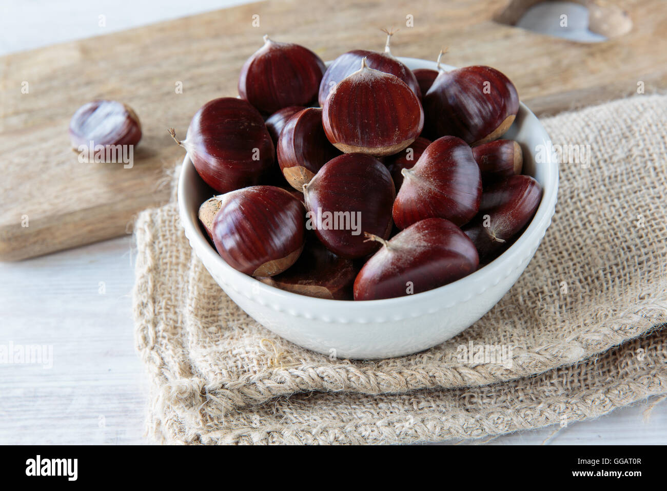 Bunch of fresh raw chestnuts in autumn season Stock Photo - Alamy
