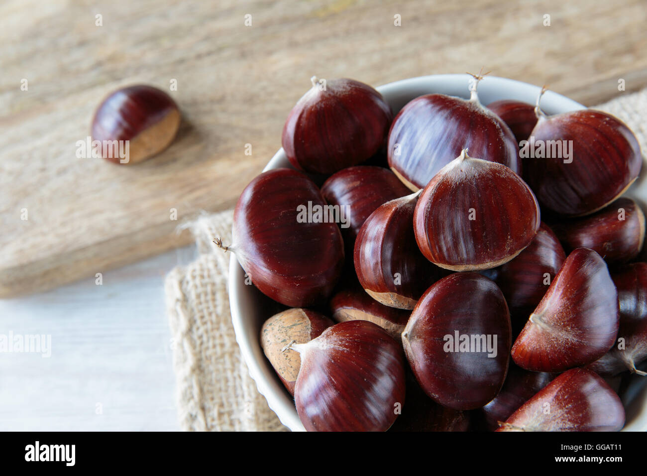 Bunch of fresh raw chestnuts in autumn season Stock Photo - Alamy