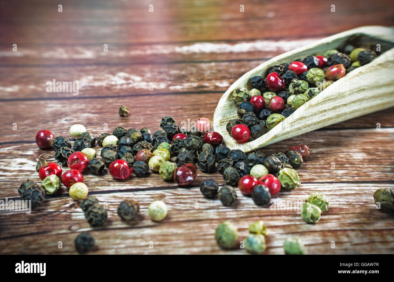 Mixed dried peppercorns on a wooden spoon Stock Photo - Alamy